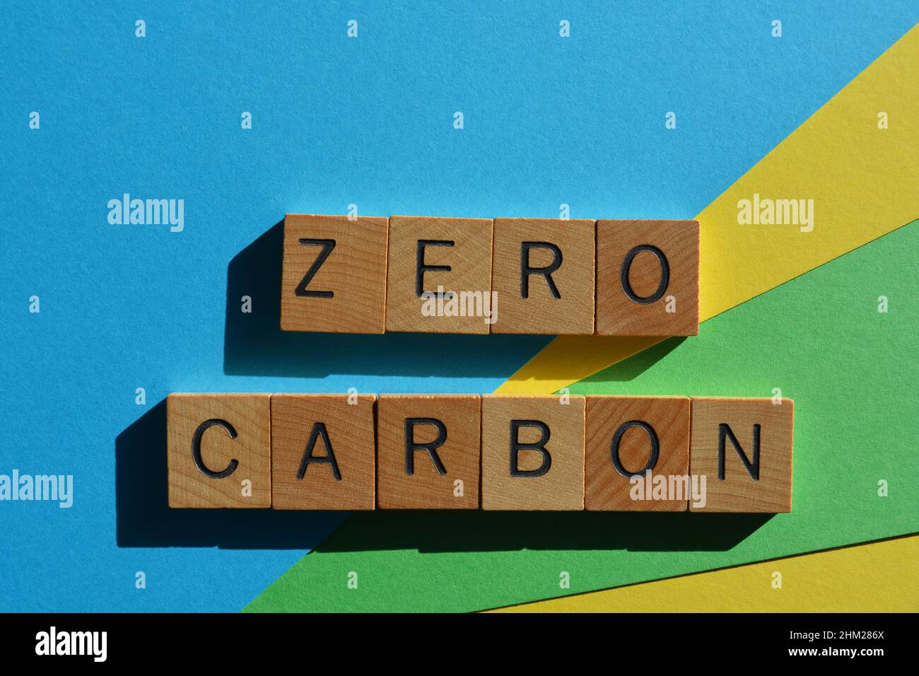 Zero Carbon, phrase in wooden alphabet letters isolated on yellow ...