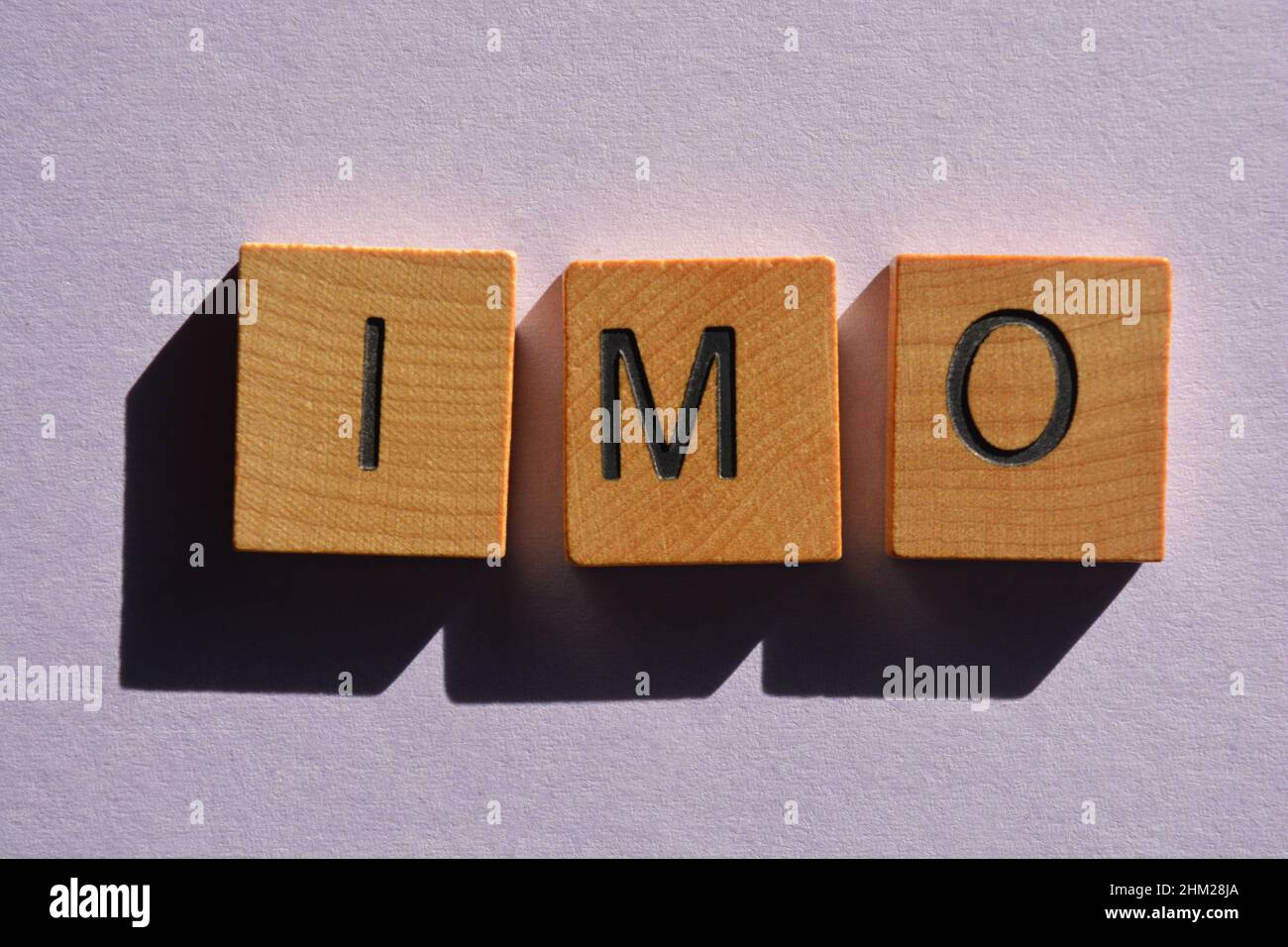 IMO, acronym In My Opinion, in wooden alphabet letters isolated on ...