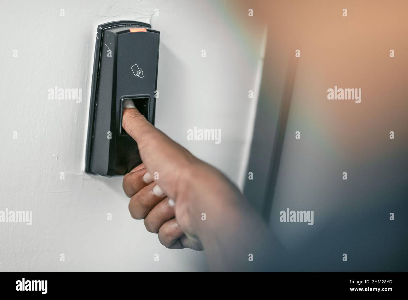 Man pressing fingerprint scanner on alarm system indoorsFinger print ...