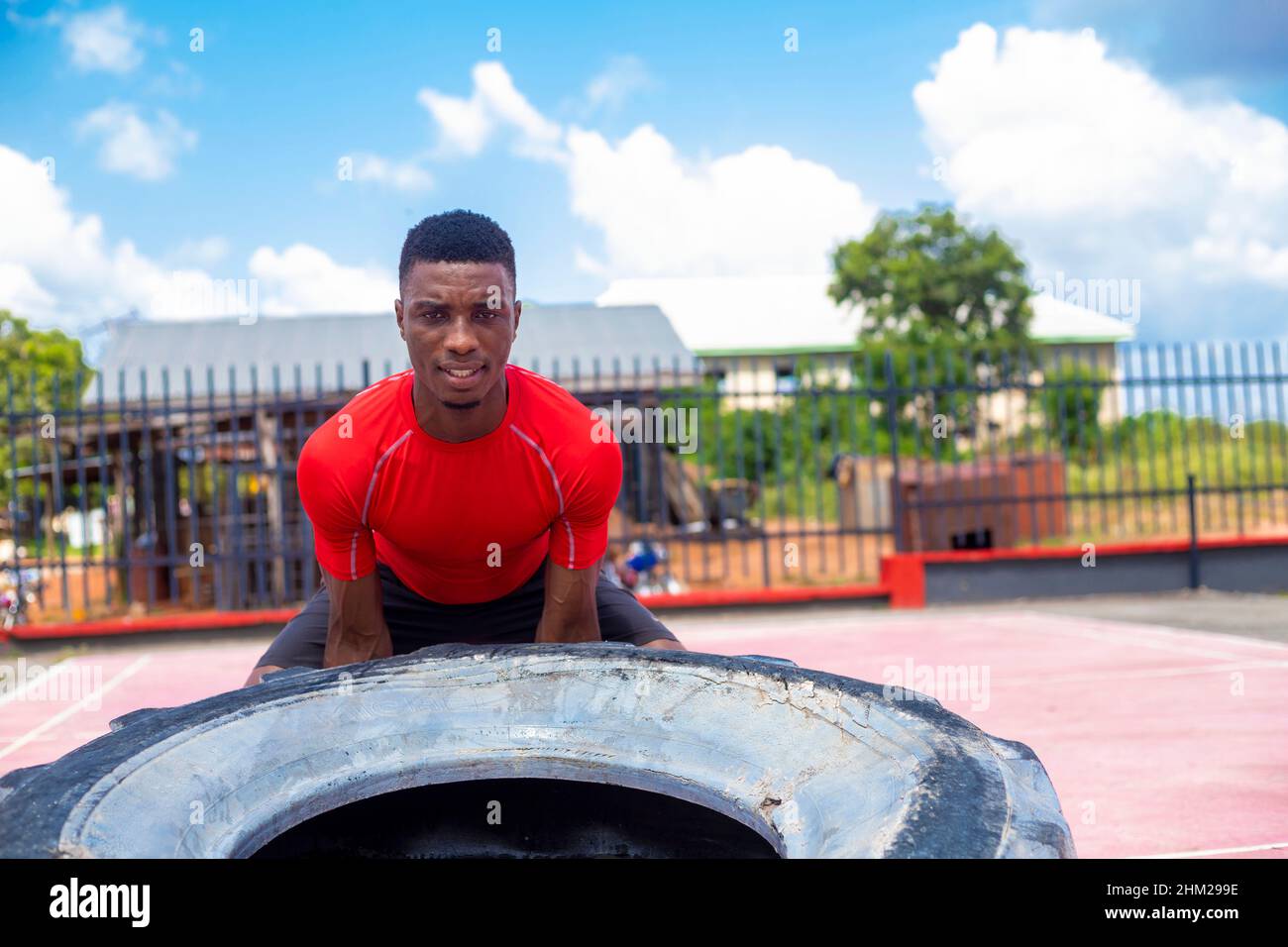 Strong man training workout lifting large tire outdoor DIY gym Stock ...