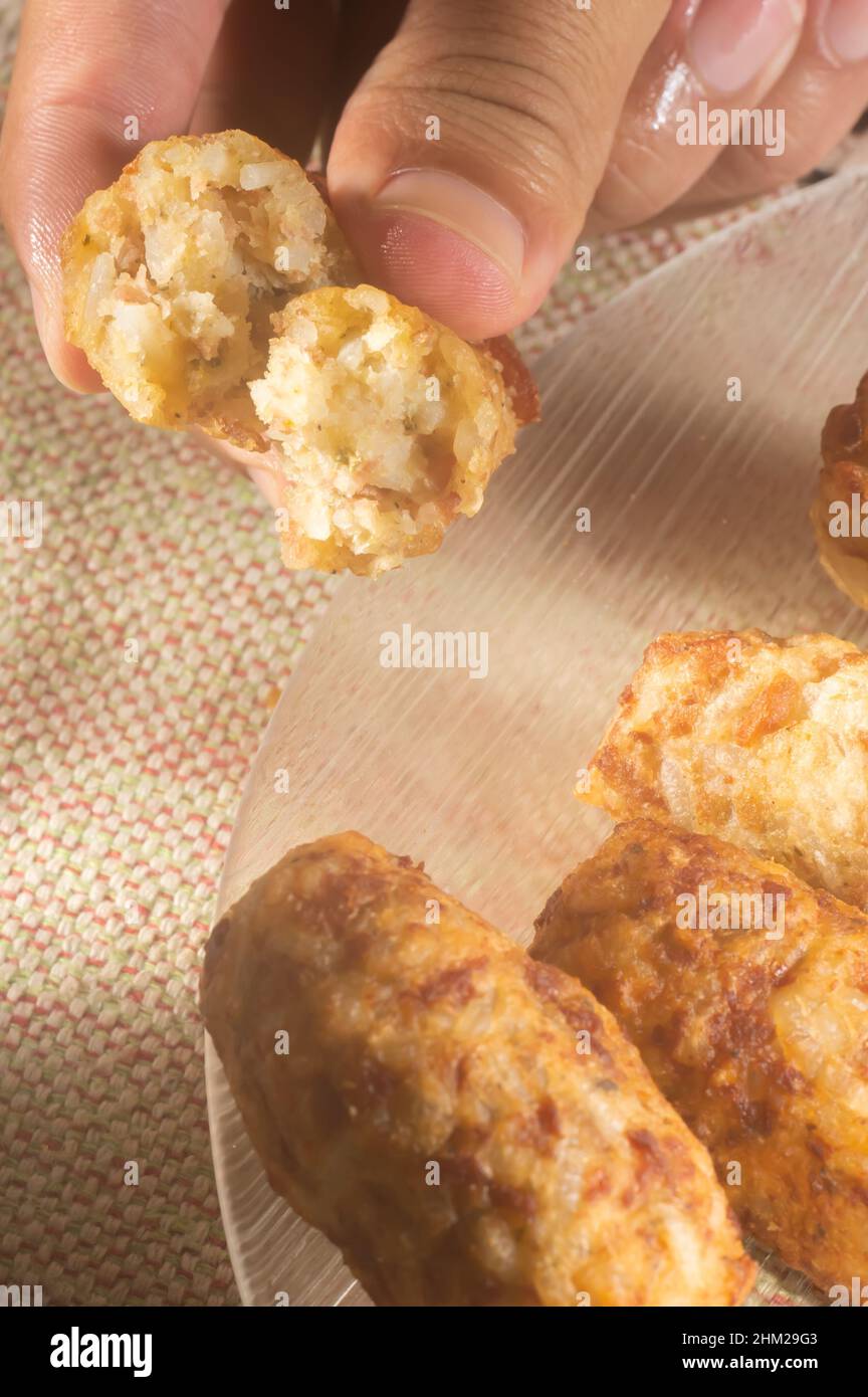 Rice patties or fritters made of cooked rice, carrot, onion, garlic ...