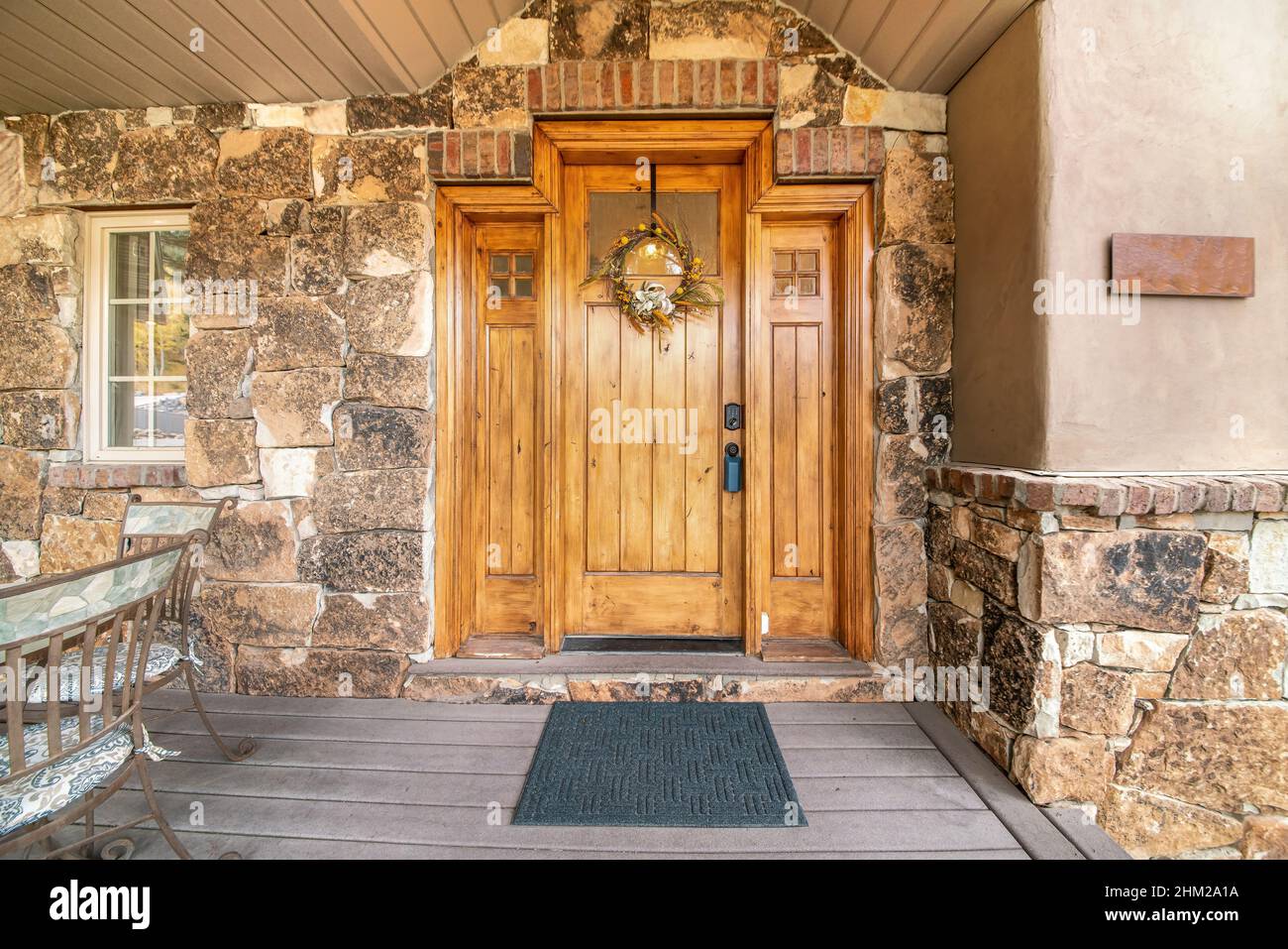 Wooden front door of a house with wreath, window and side panels Stock ...