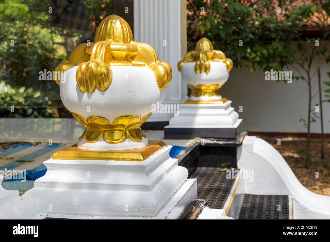 Filled pot (Punkalasa) painted in white and gold in a Sri Lankan temple ...