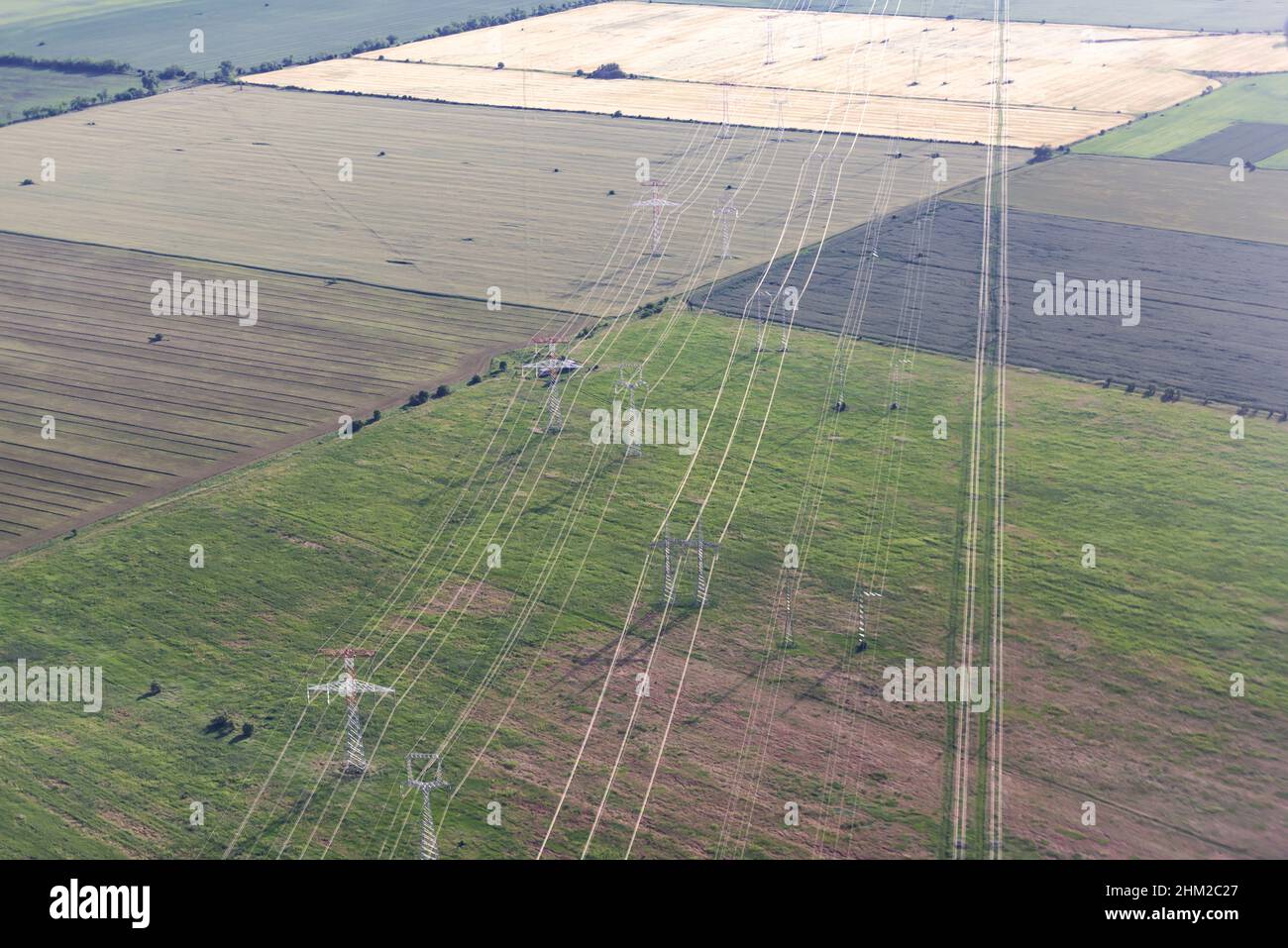 Green fields with a power line. Spring European fields taken from an ...