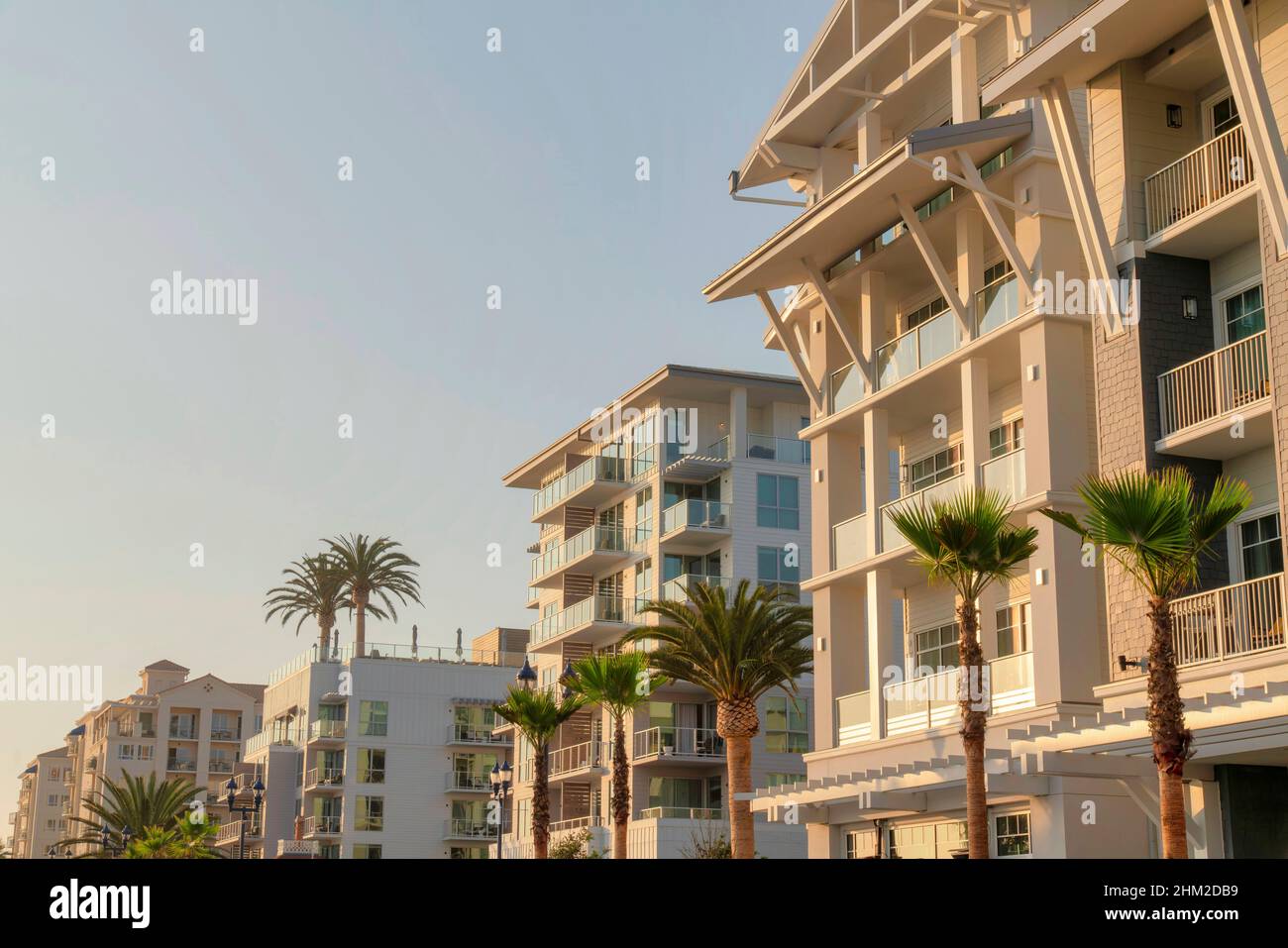 Row of apartment buildings with glass railings on the balconies at ...