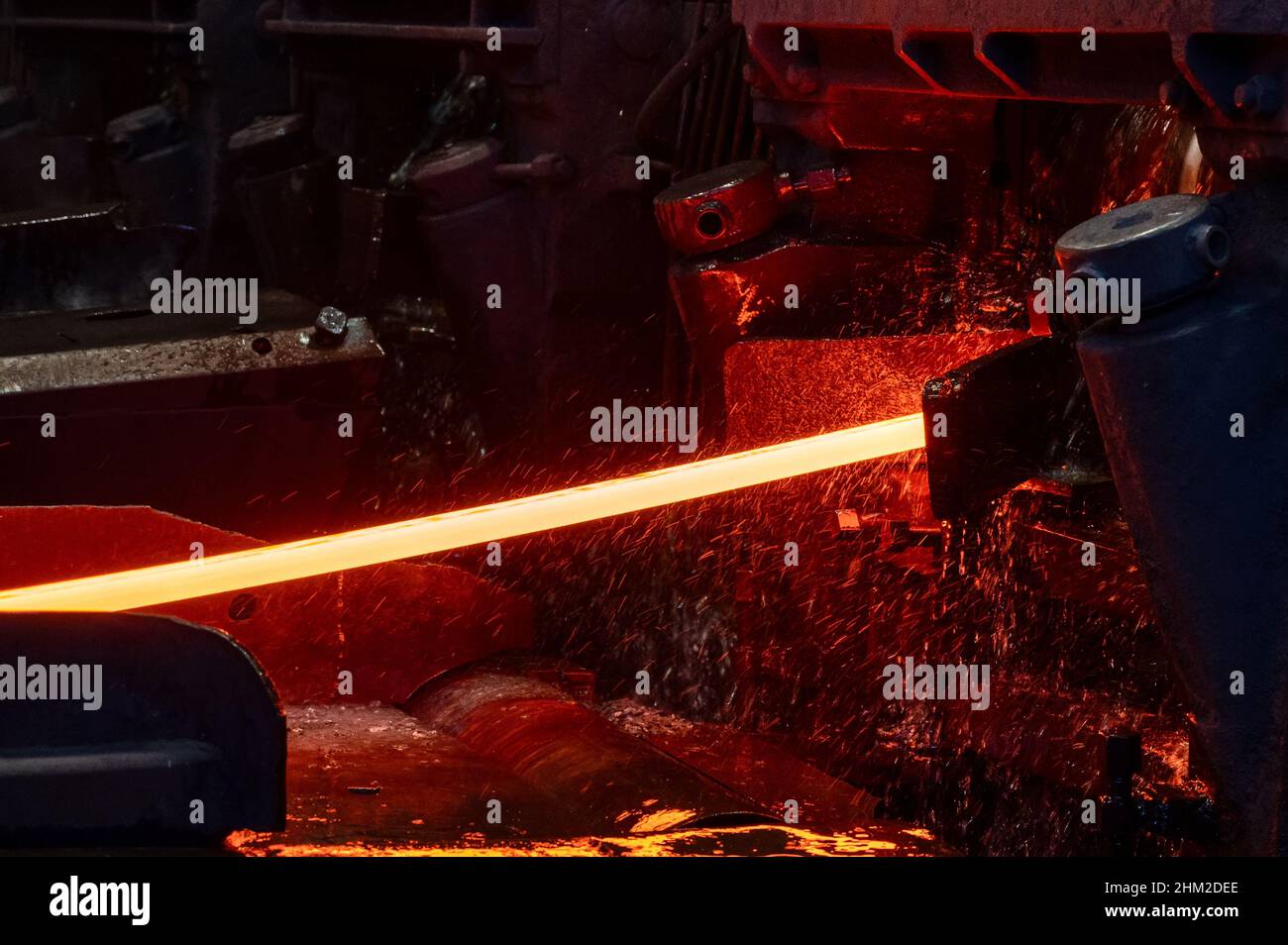 Red-hot metal billet on the roller table of a rolling mill Stock Photo ...
