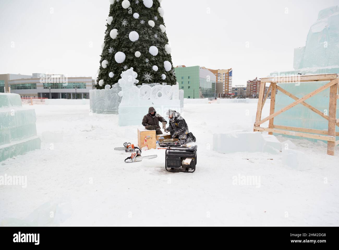Workers at the construction site of the ice town prepare the tool for ...