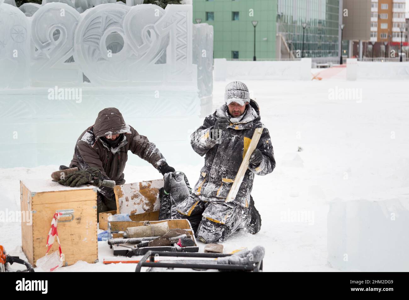 Workers at the construction site of the ice town prepare the tool for ...