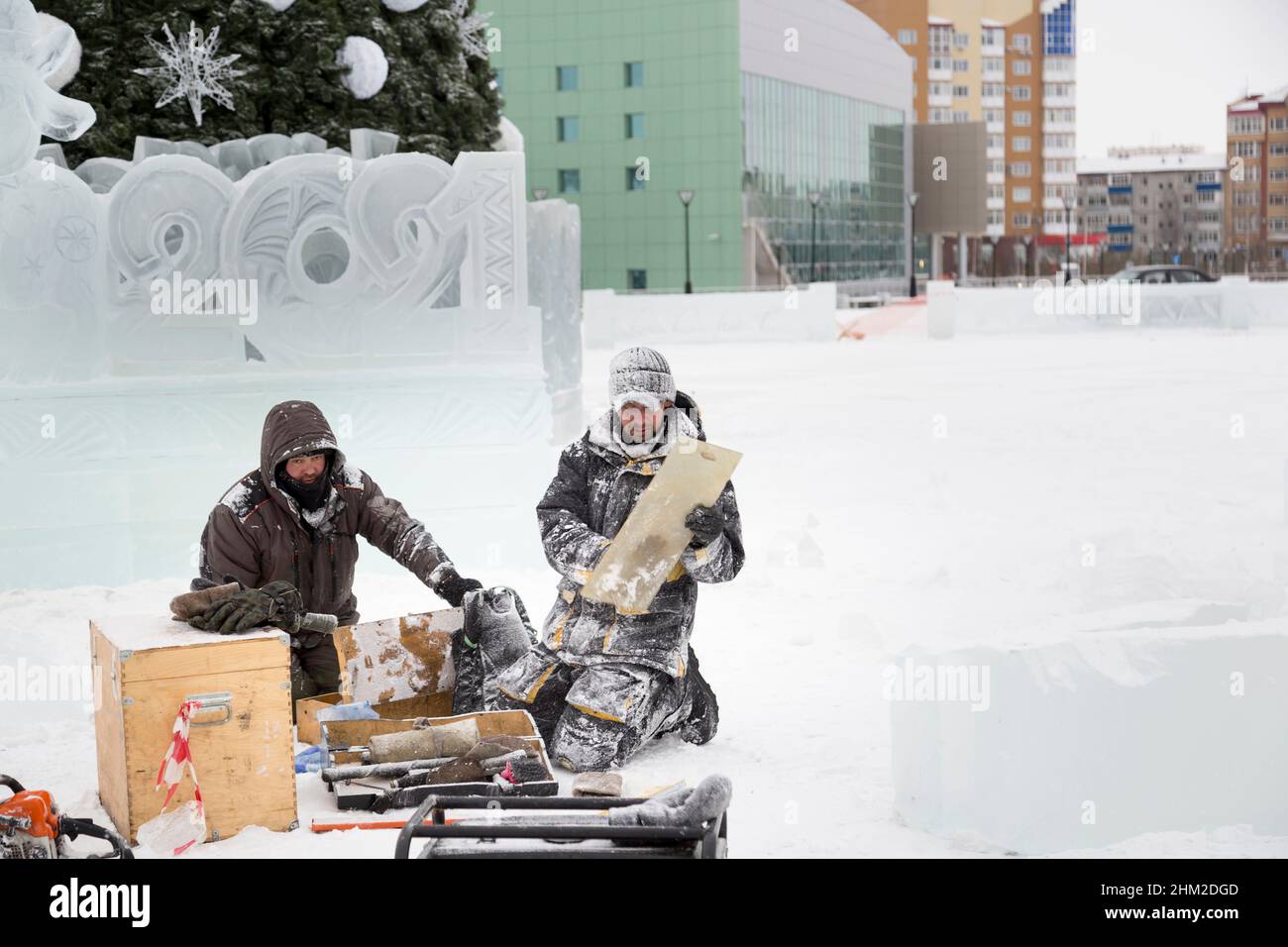 Workers at the construction site of the ice town prepare the tool for ...
