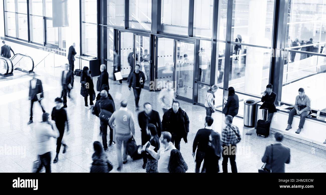 large crowd of blurred business people rushing at a airport Stock Photo ...