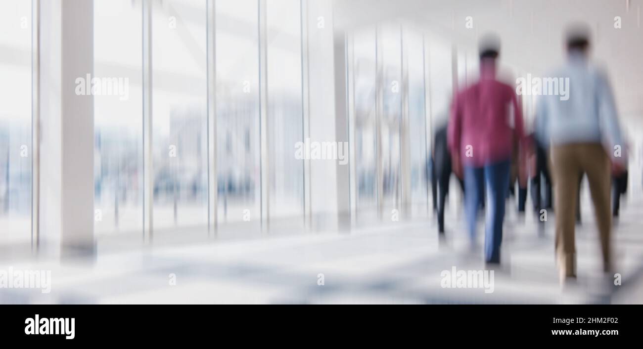 Intentionally blurred commuters in a modern environment background ...