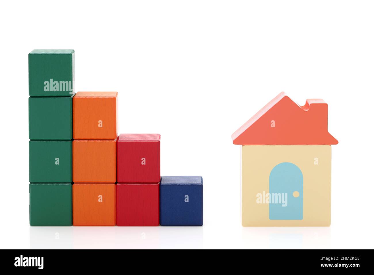 small toy house and wooden colorful building blocks on white background ...
