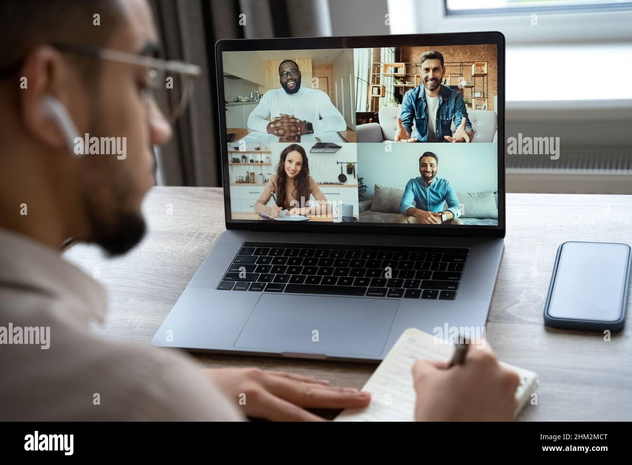 Back rear view of employee involved in video conference brainstorming ...