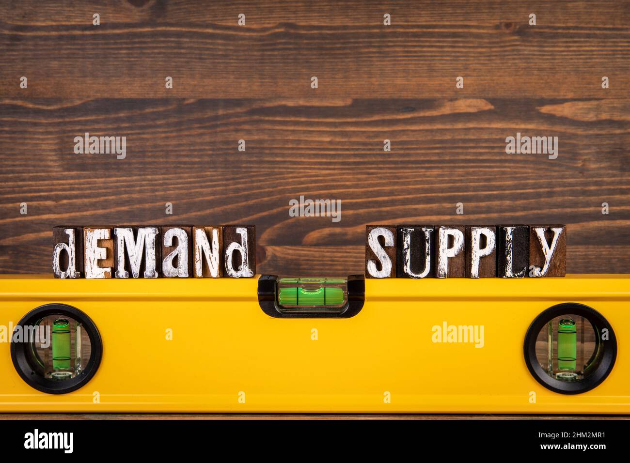 Demand and Supply balance koncept. Yellow spirit level Stock Photo - Alamy
