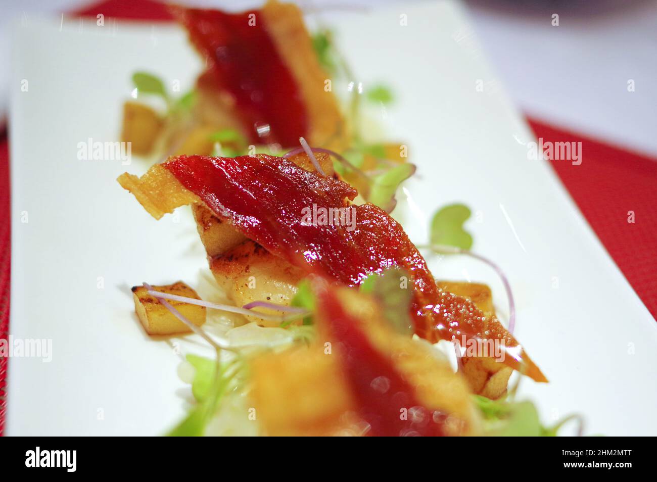 sliced dry cured iberico ham on seared scallop and conpoy Stock Photo ...