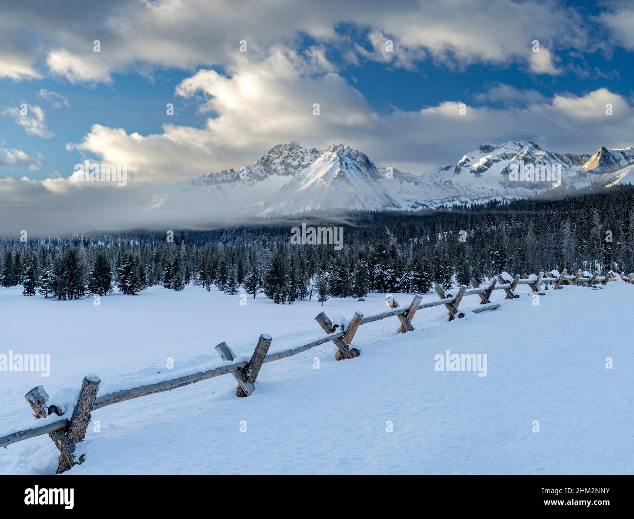 Pole fence helps frame view of winter Sawtooth’s Stock Photo - Alamy