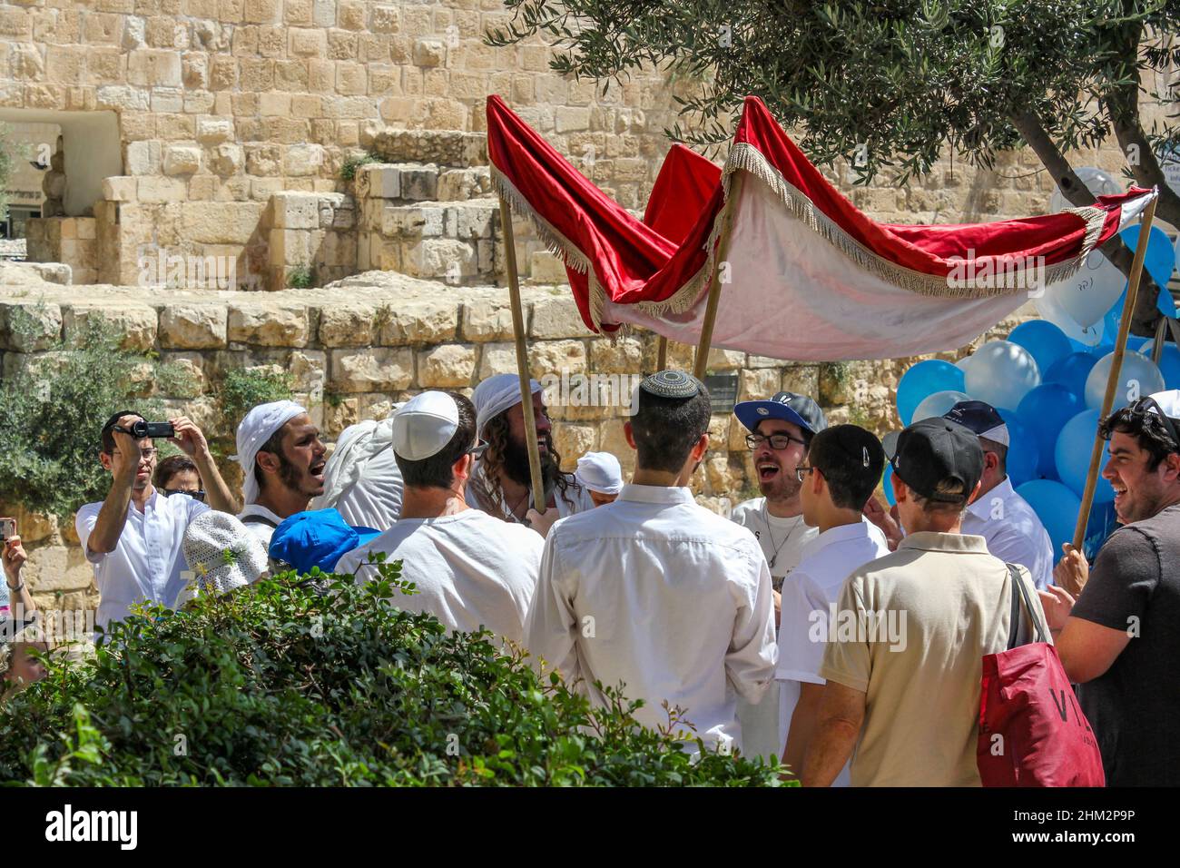 Participants in a Jewish Bar Mitzvah celebration carry a chuppah near ...