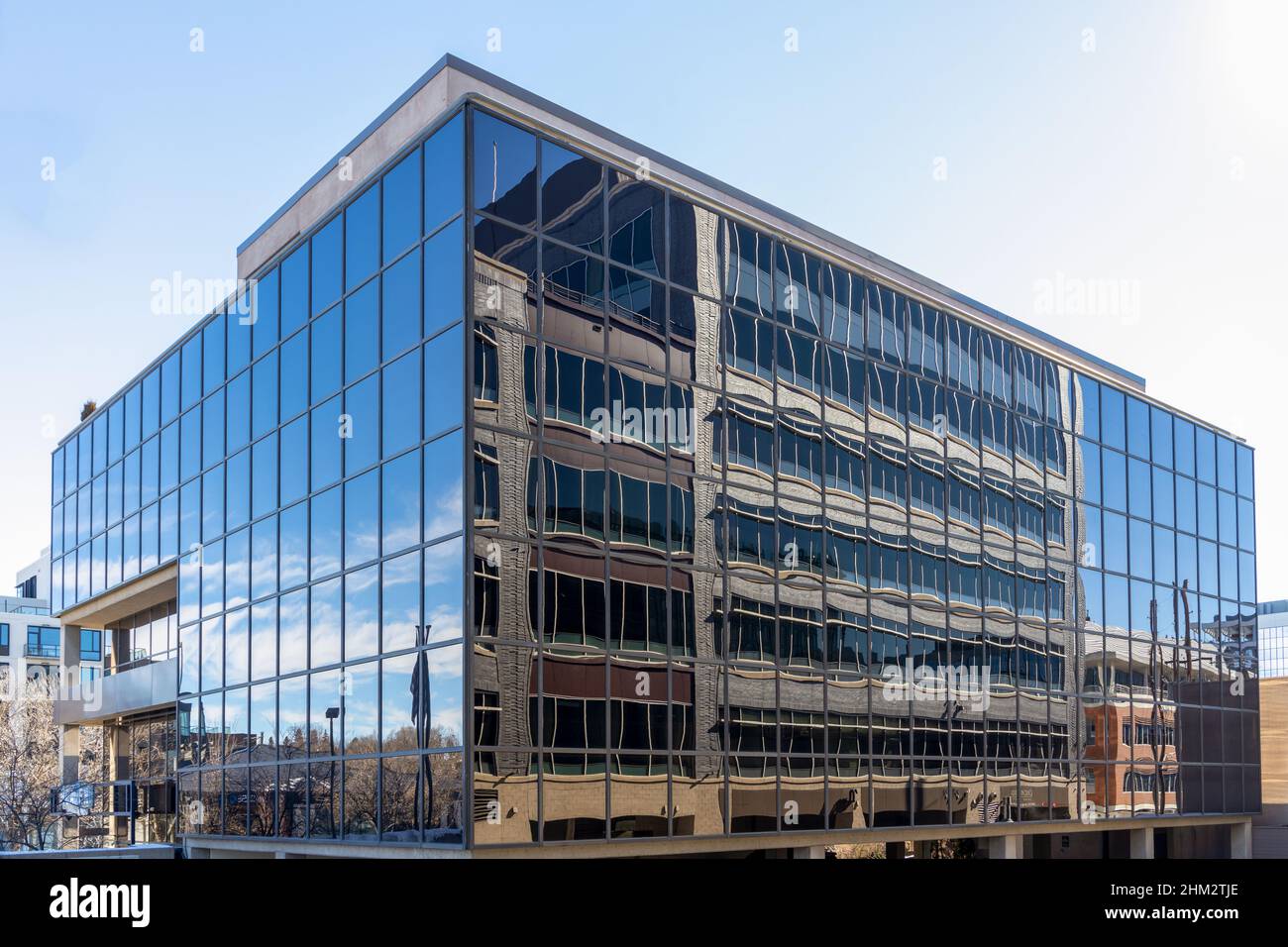 An office building with the glazed facade and reflections Stock Photo ...