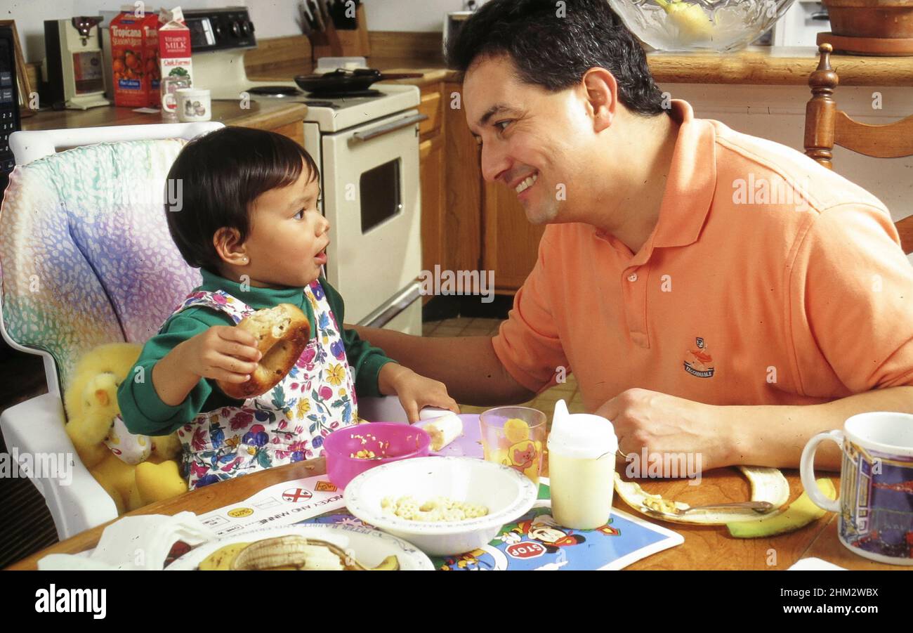 Austin Texas USA, 1995: Hispanic dad supervises breakfast for his ...