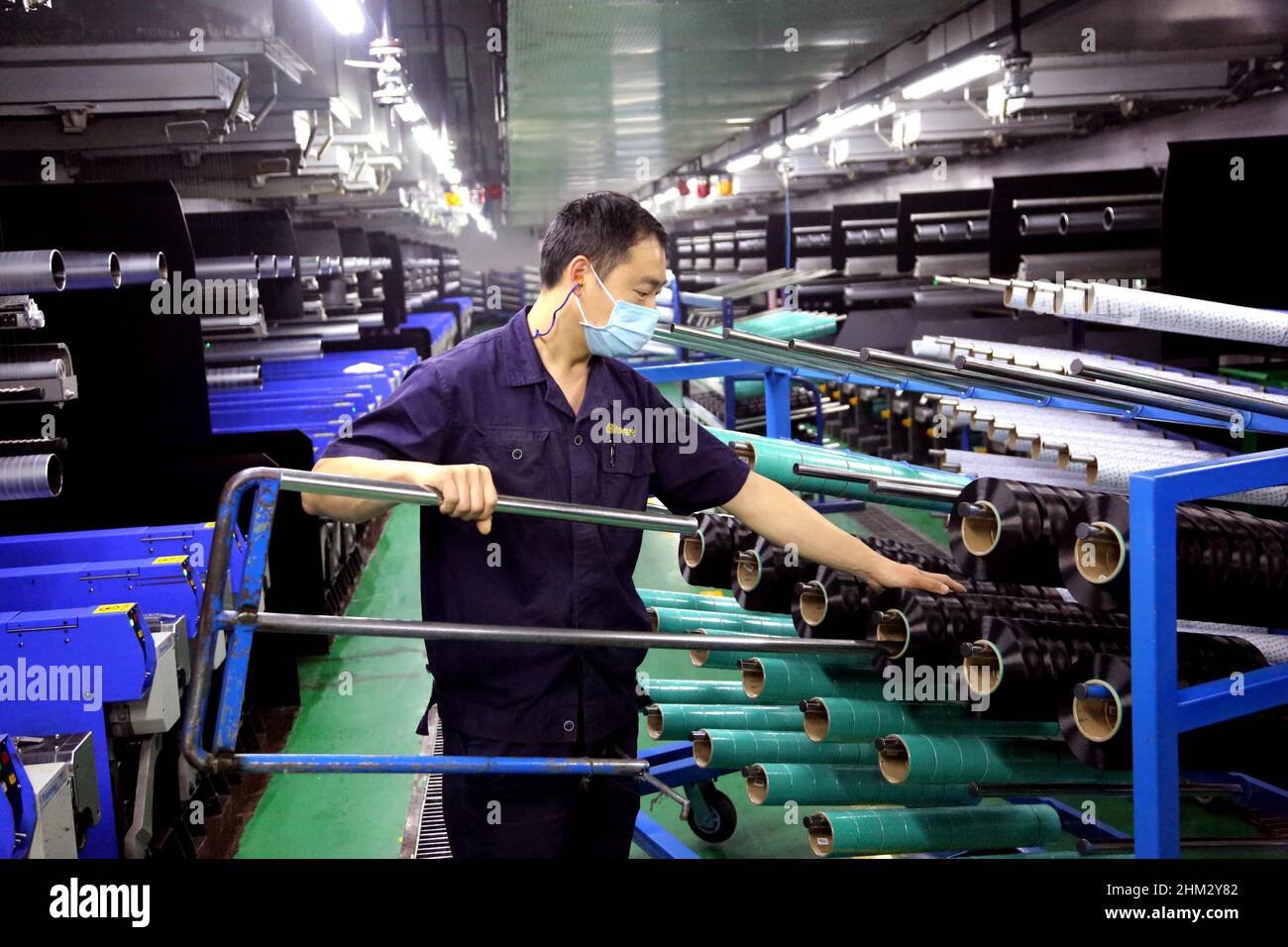LIANYUNGANG, CHINA - FEBRUARY 7, 2022 - A worker processes spandex ...