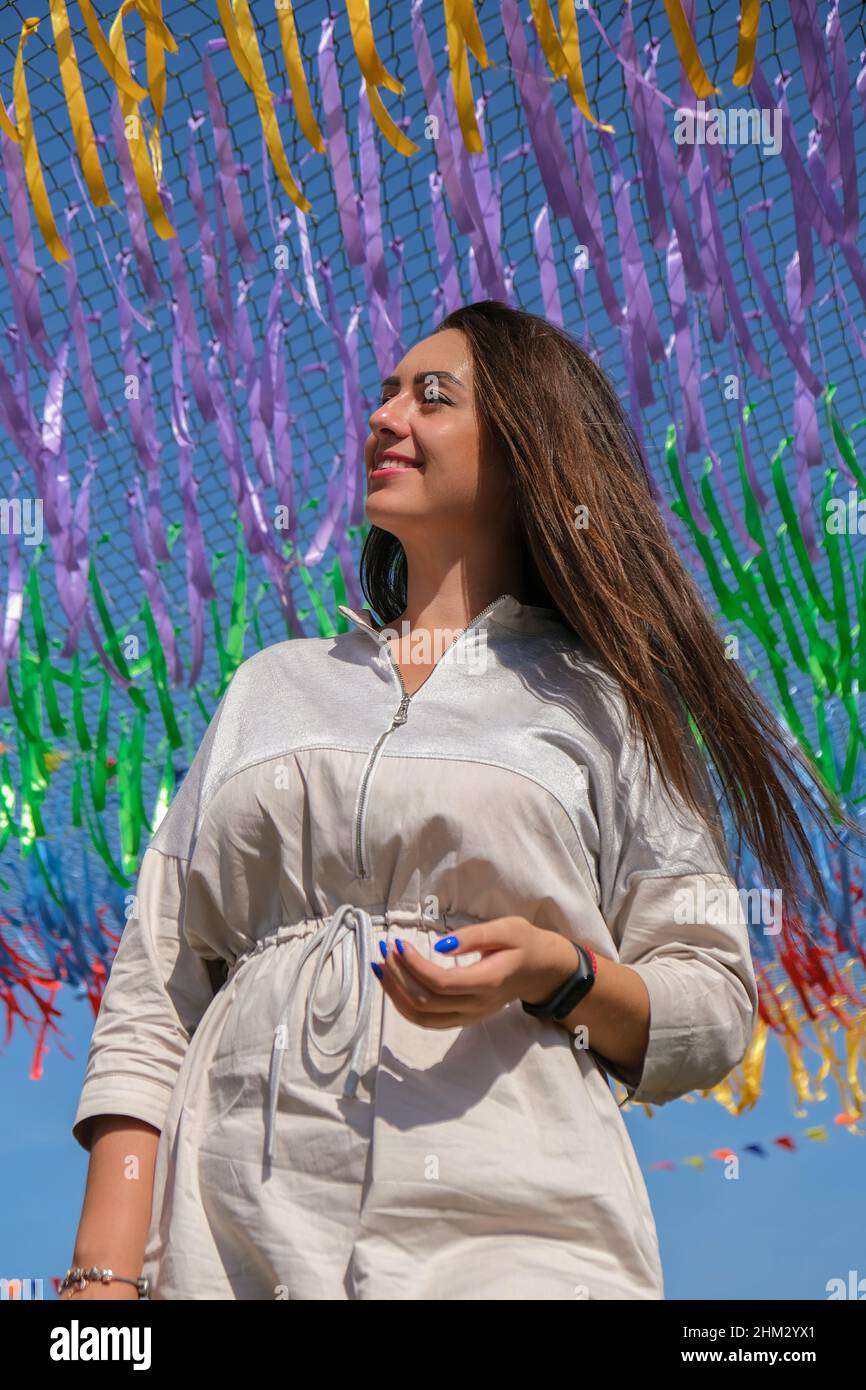 Young woman sitting on festival. Gen z girl enjoying outdoors ...