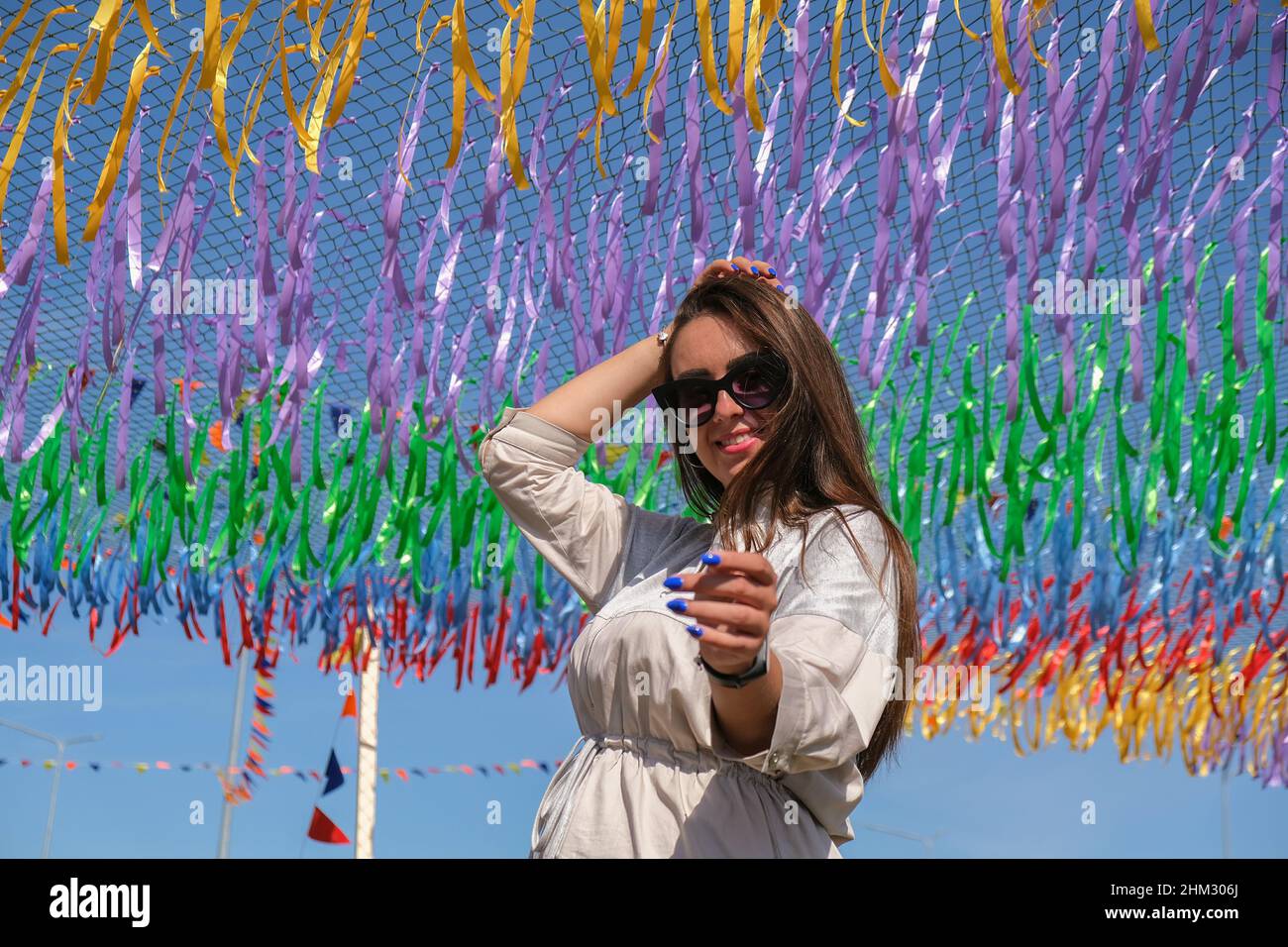 Young woman sitting on festival. Gen z girl enjoying outdoors ...
