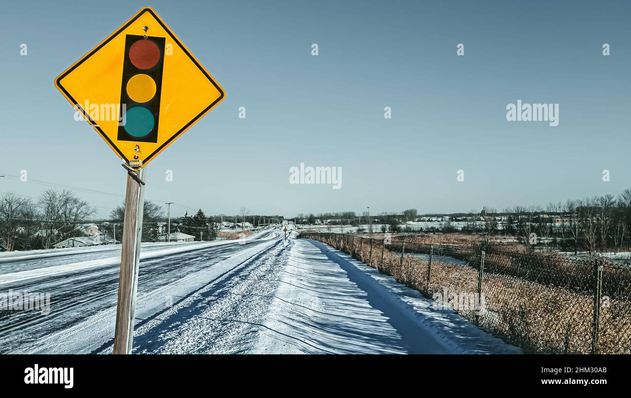Stop and go sign with snow covered roads and sidewalk.Frozen landscape ...