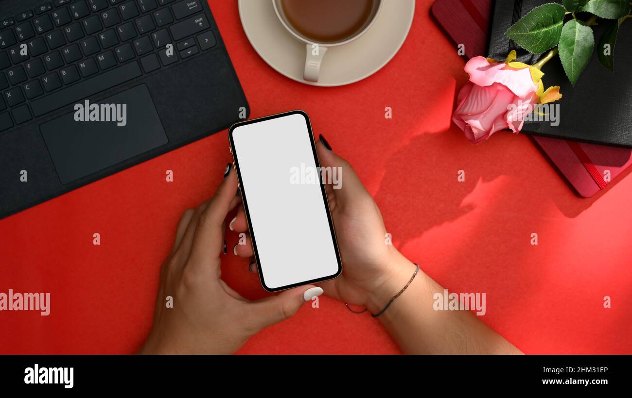 Top view image of hands holding an empty screen smartphone mockup over ...