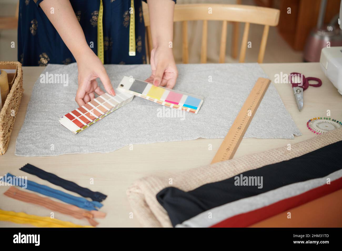 Hands of dressmaker using color palette when choosing lining color for ...