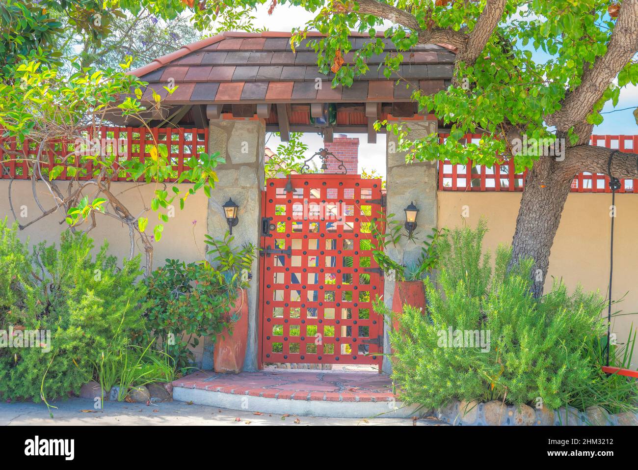 Arbor gate with two wall lamps on the concrete posts at La Jolla, San ...