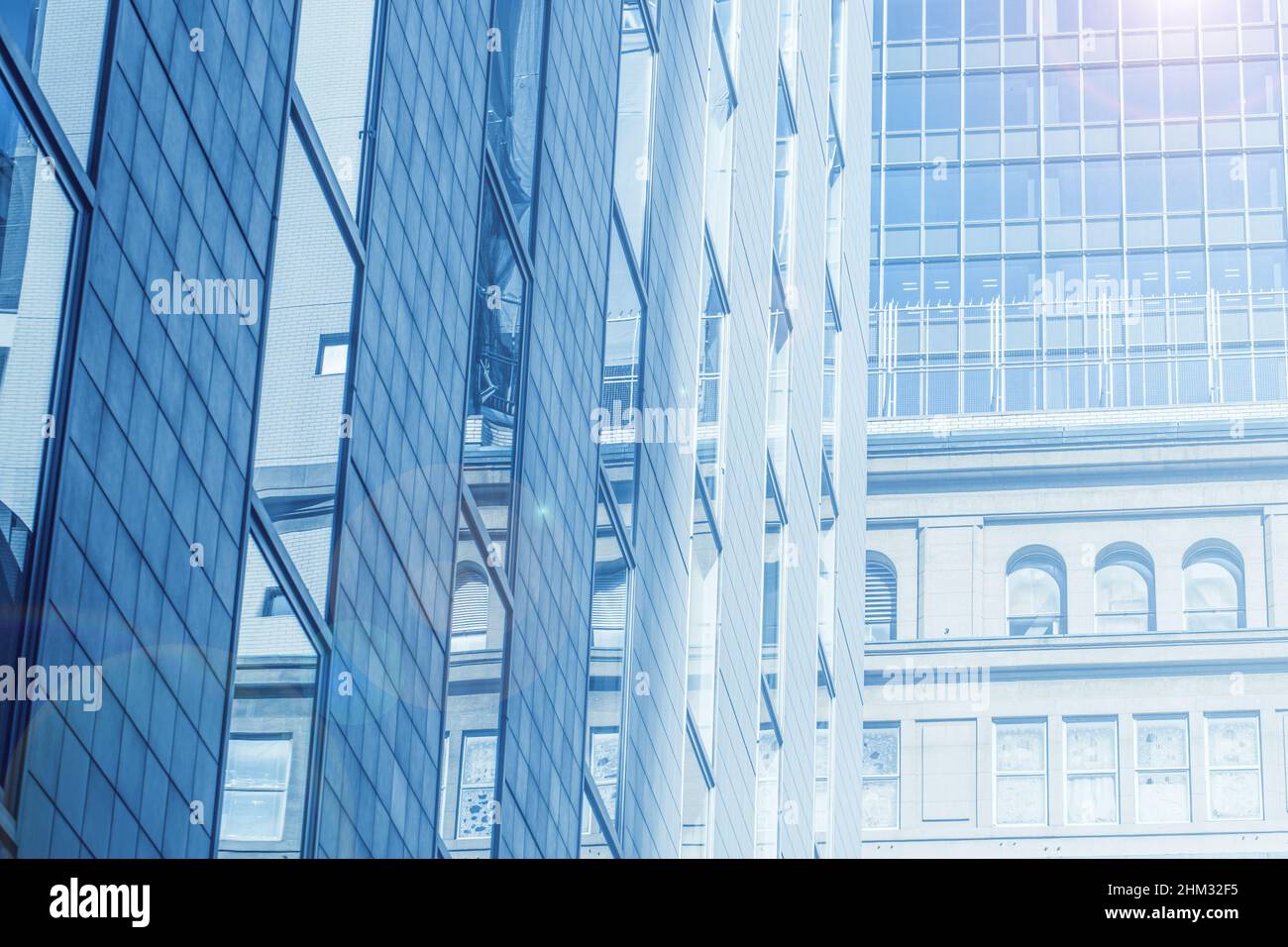 urban business office building glass windows in large metro city blue ...