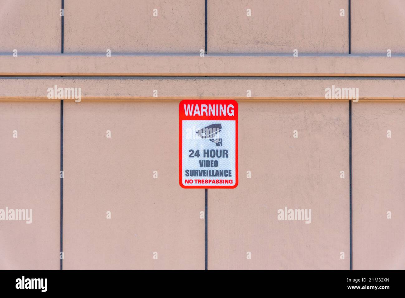 Warning signage on a concrete wall with staight lines at La Jolla, San ...