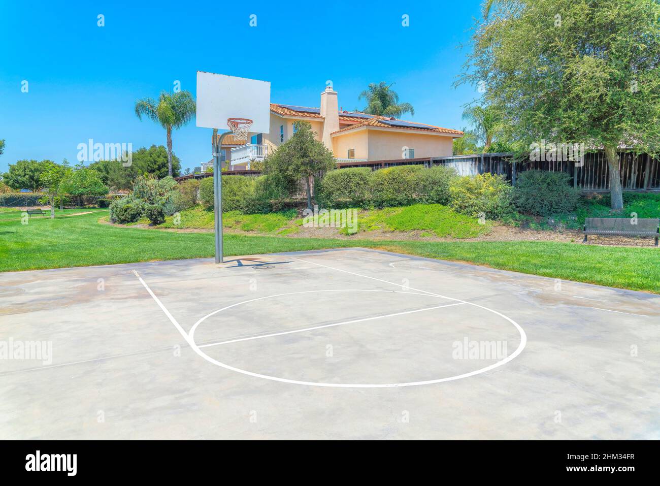 Single basketball court in a park with green lawn at San Diego ...