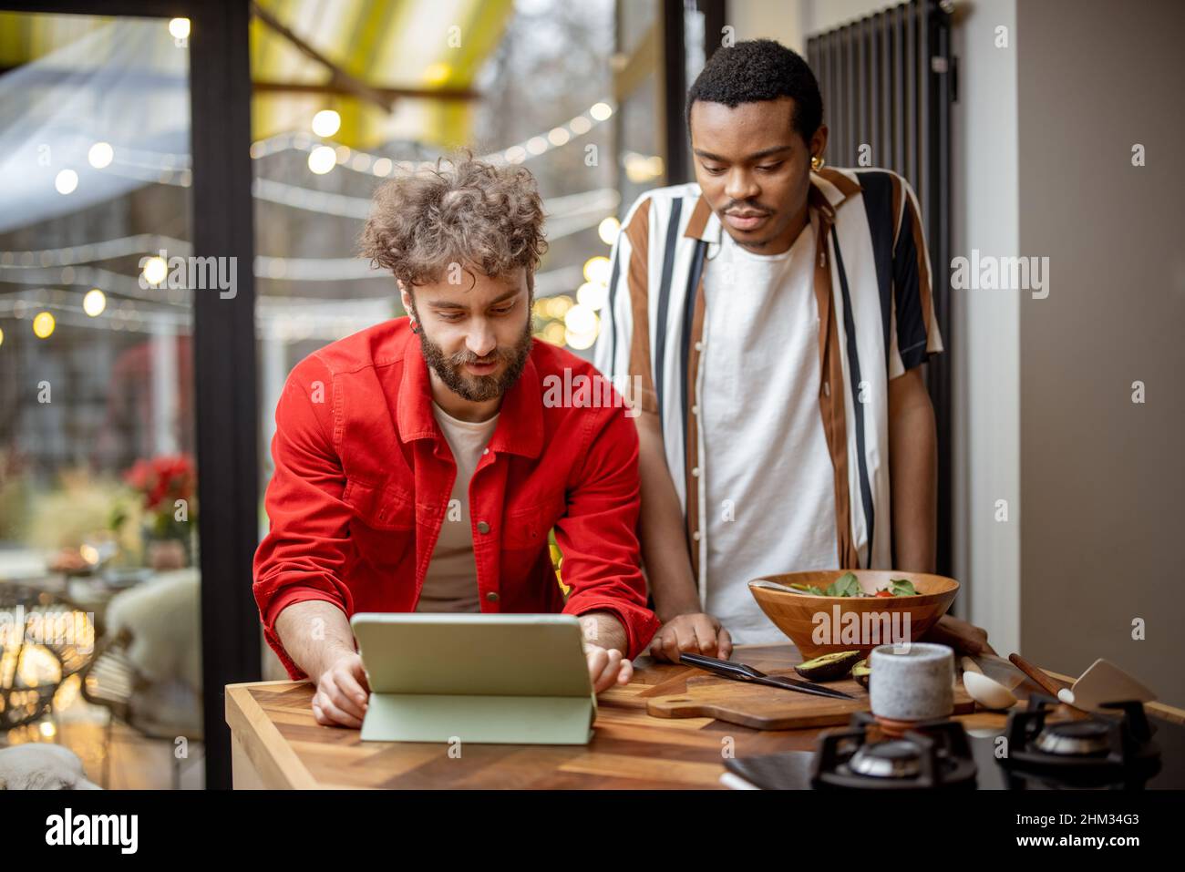 Two guys watching movie together on digital tablet at home Stock Photo ...