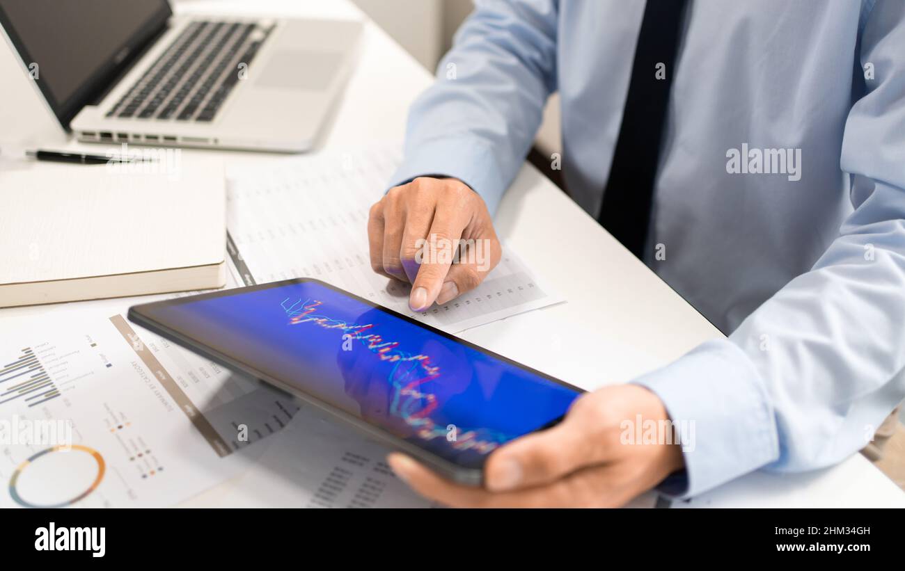 Working Man Conept The male employee sitting at his desk, holding a ...