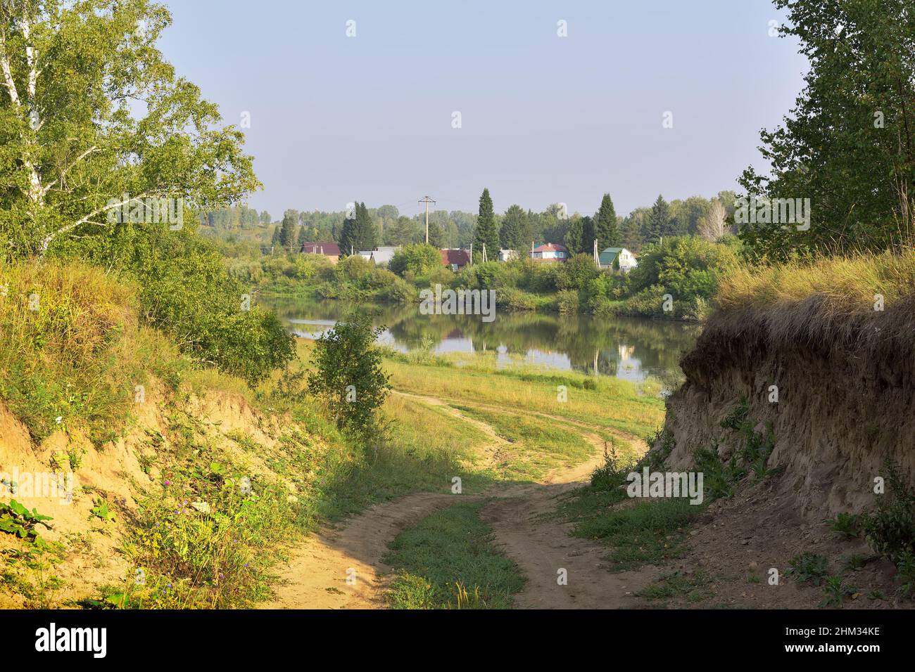 A steep descent to the steep Bank of the river in the morning light ...