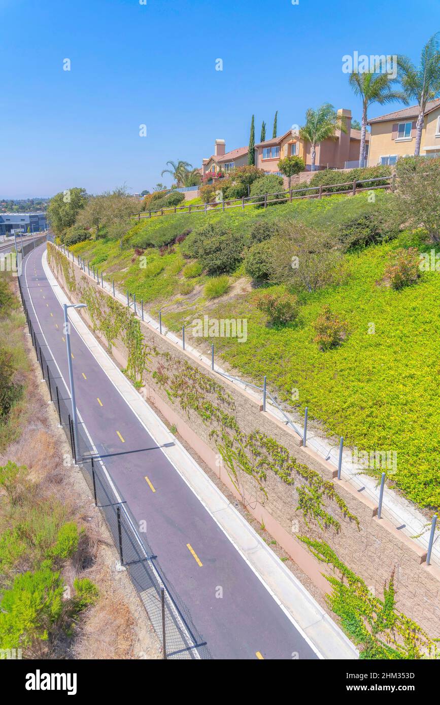 Bike path near the slope with shrubs and grass at San Marcos, San Diego ...