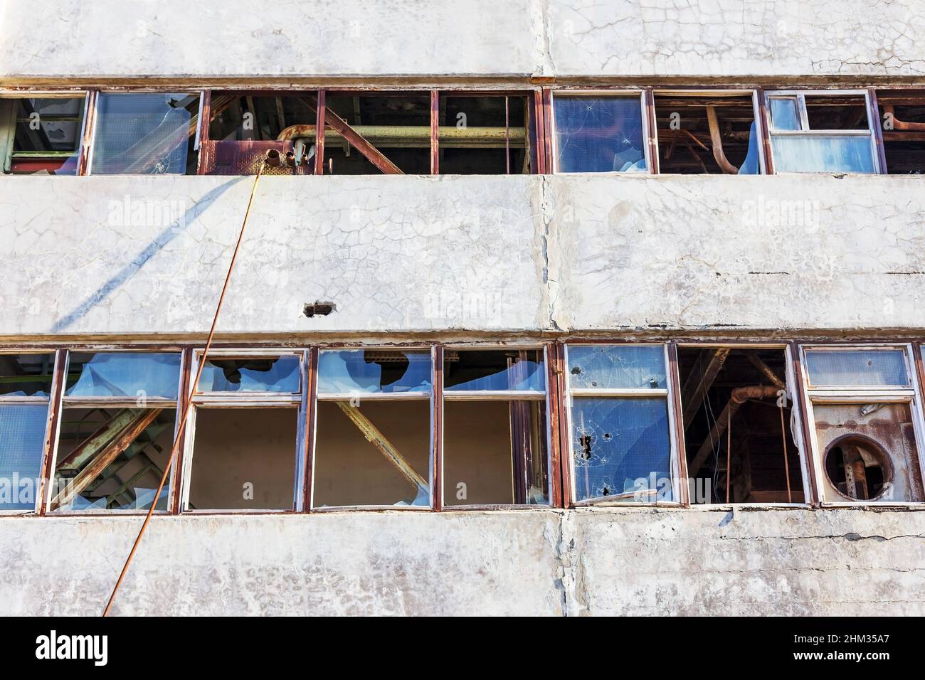 Broken glass window in the old abandoned industrial building. The ...