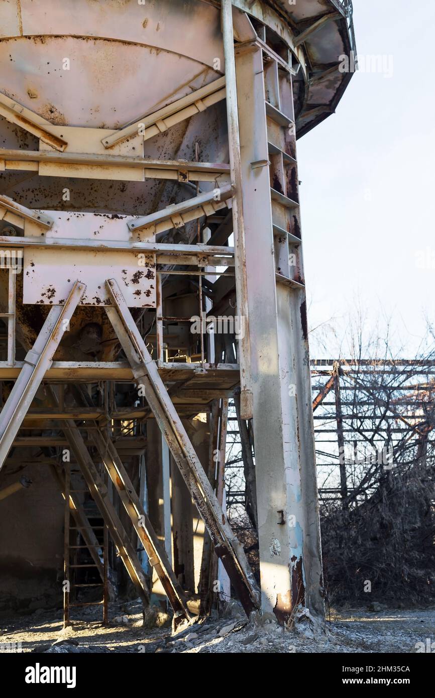 Old, abandoned concrete plant with iron rusty tanks and metal ...