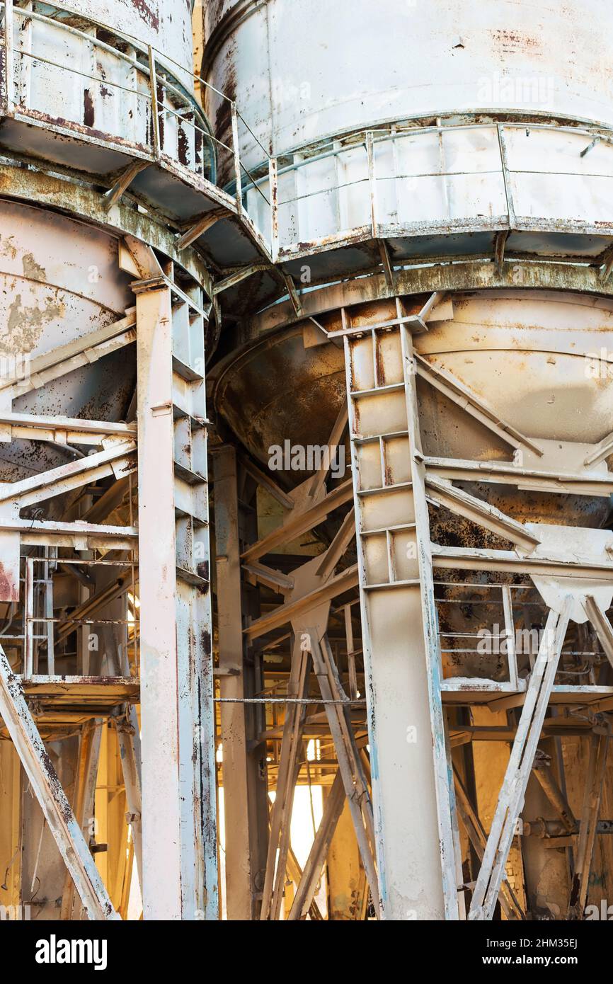 Old, abandoned concrete plant with iron rusty tanks and metal ...