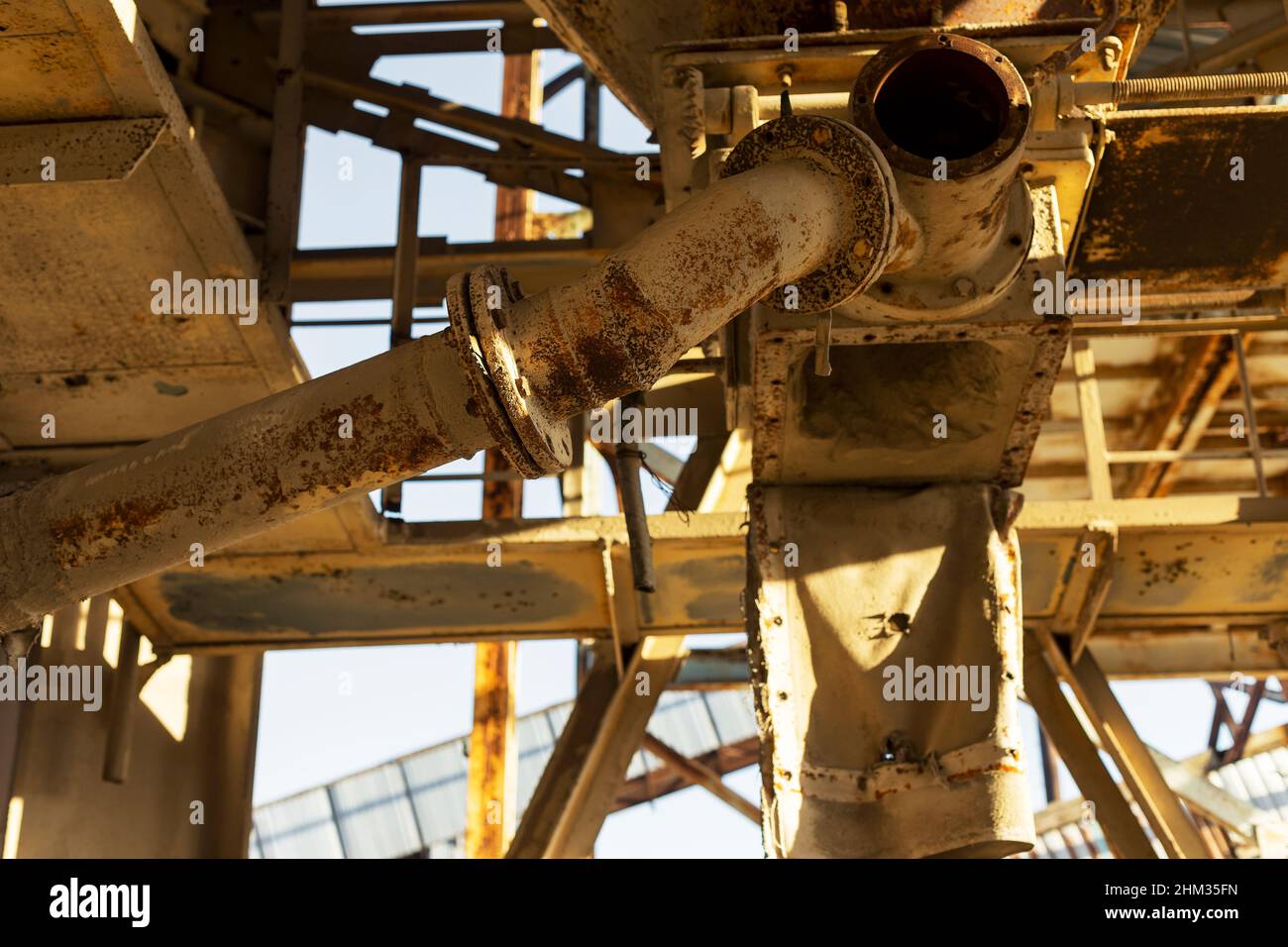 Old, abandoned concrete plant with iron rusty tanks and metal ...