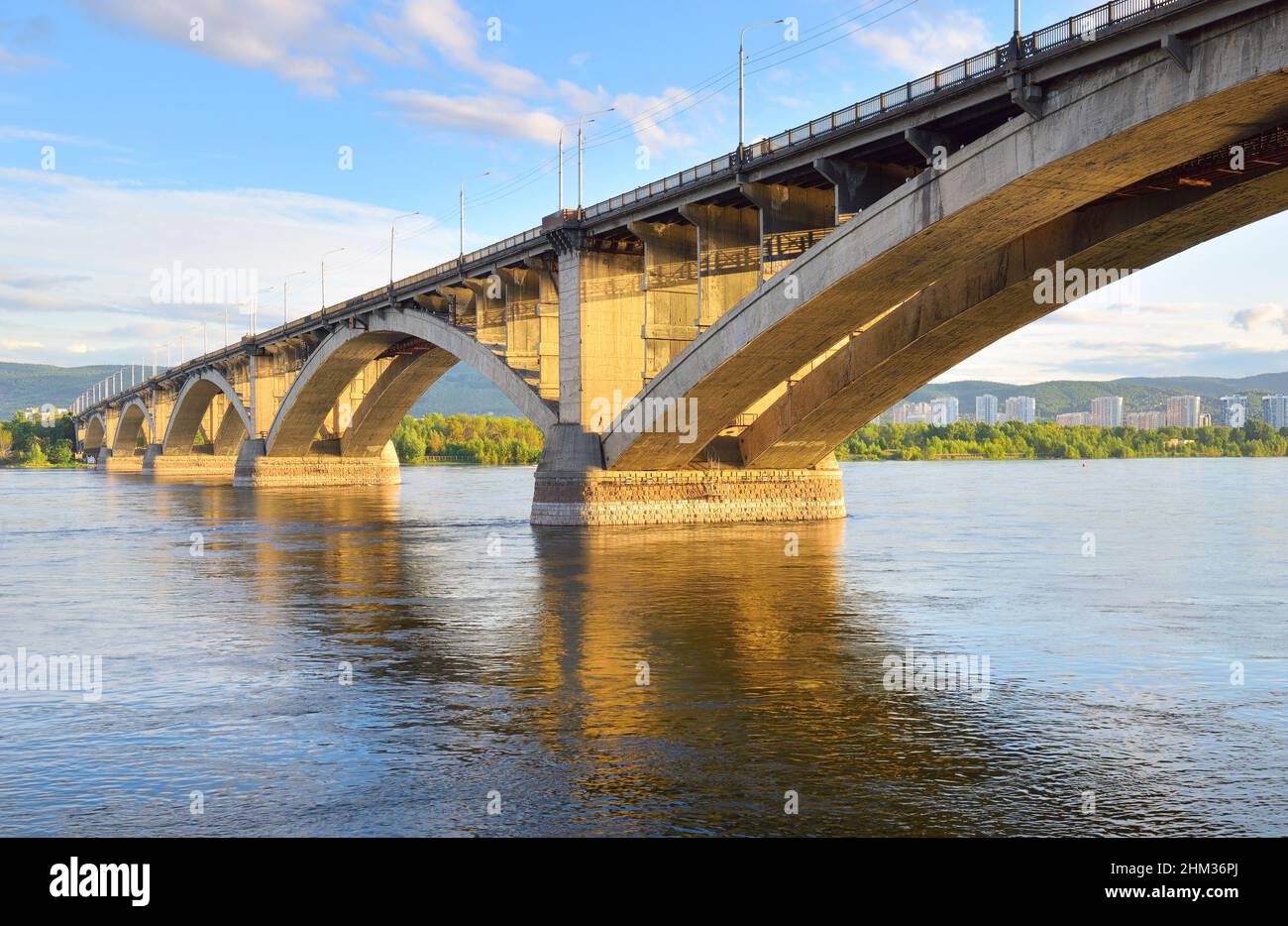 Arched bridge over the Yenisei River under a blue sky. Siberia, Russia ...