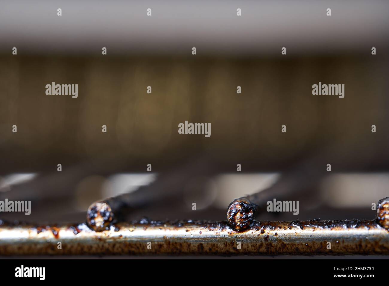 Greasy grill rust from the front. Wire brush blurred in the background ...