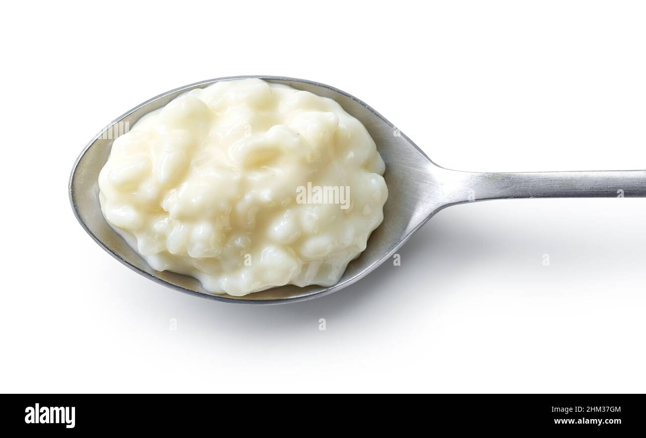spoon of rice and milk pudding isolated on white background, top view ...