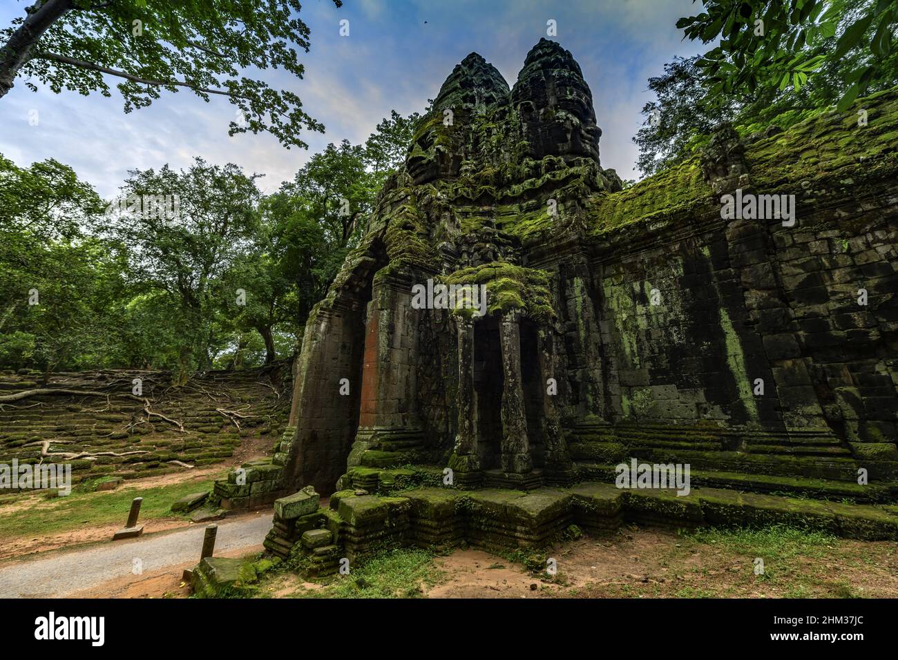 Low angle shot of the mossy gates and walls of Angkor Thom in Angkor ...