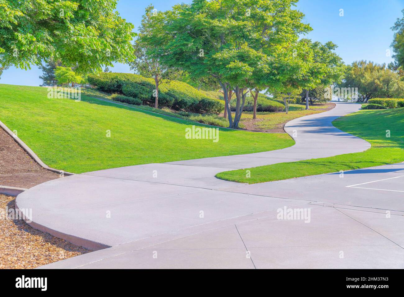 Concrete curvewd pathway in a clean park at San Diego, California Stock ...