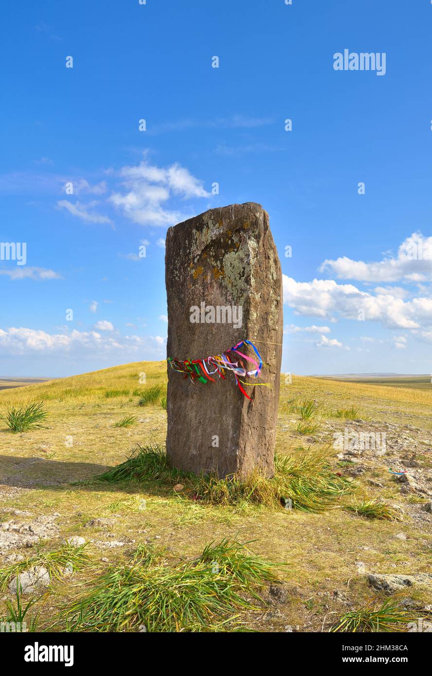An ancient mound under a cloudy blue sky. Siberia, Russia Stock Photo ...