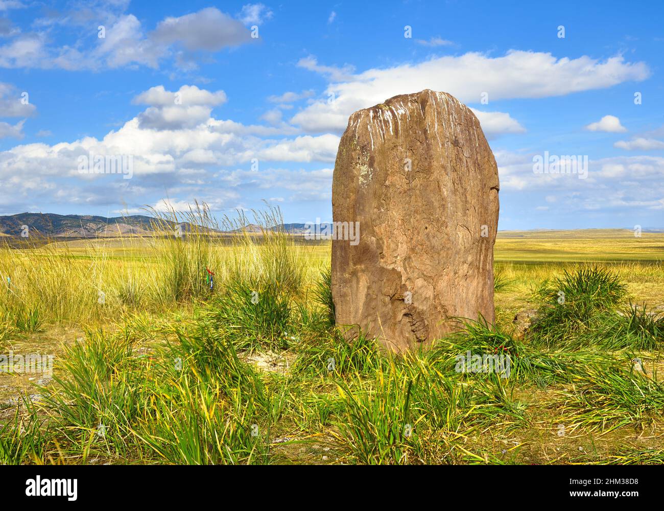 An ancient mound under a cloudy blue sky. Siberia, Russia Stock Photo ...