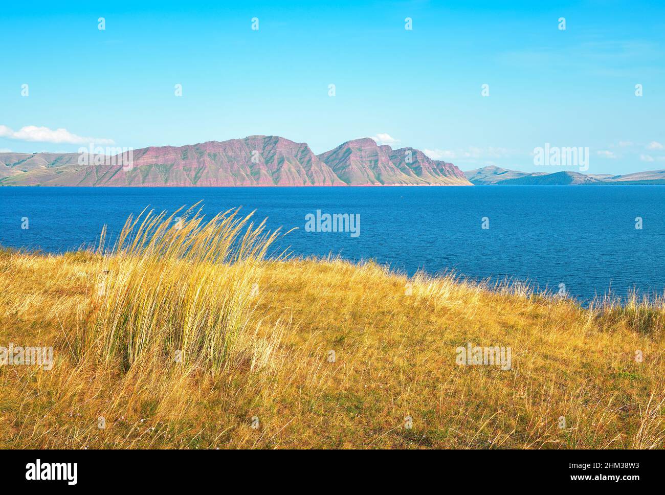 Steppe plain on the background of Mount Tepsey under a blue cloudy sky. Siberia, Russia Stock ...
