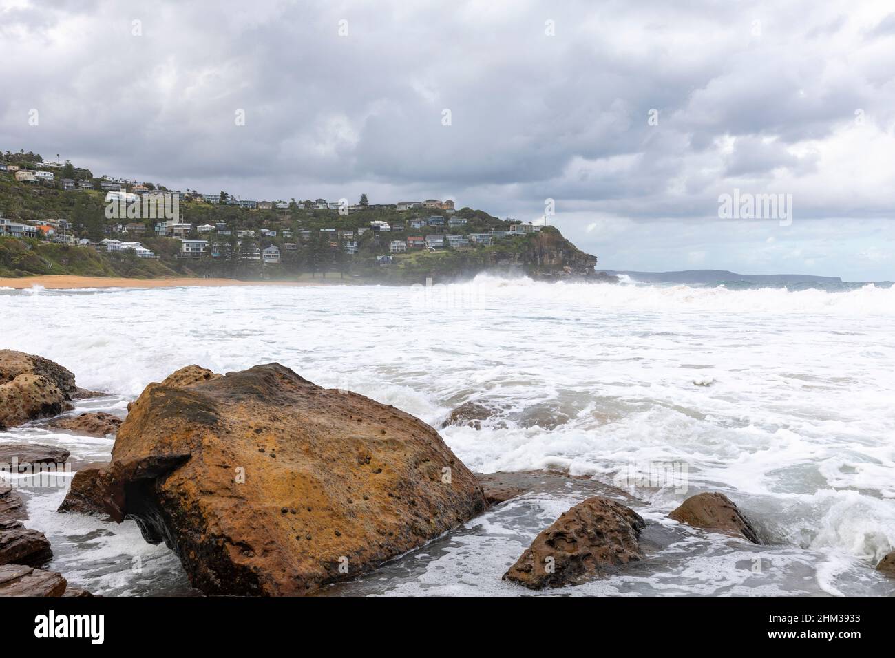 Whale Beach Sydney, rock platforms and grey skies over the beach and ...